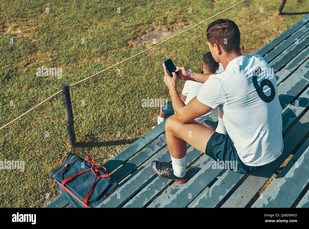 Missed the game Catch up online. a rugby player using his cellphone ...