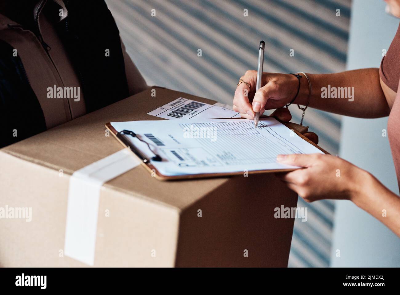 Your parcel will be released once you sign for it. Closeup shot of an ...
