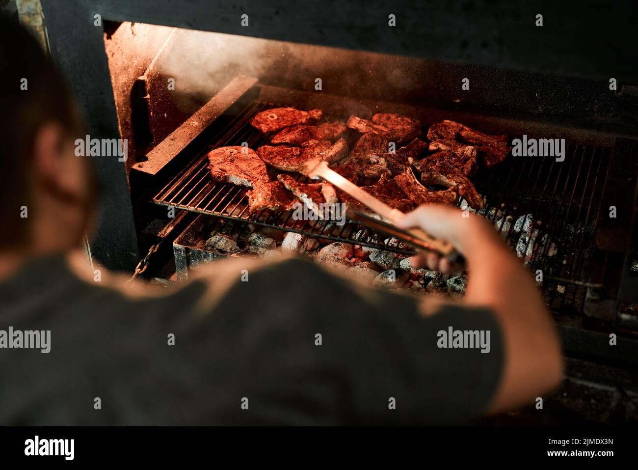 Hes on barbecuing duties. Closeup shot of an unrecognisable man ...