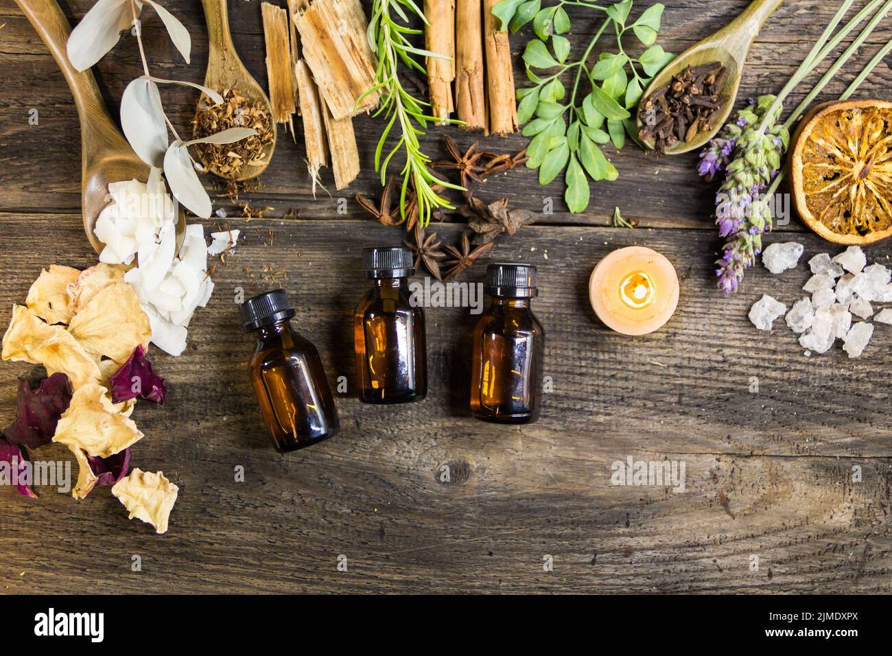 Set of aromatic incense and natural flowers and herbs on rustic wood ...