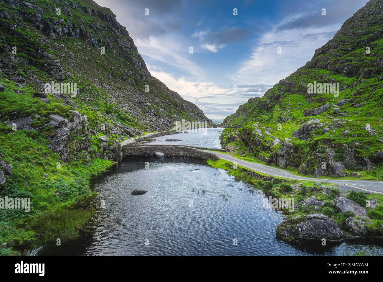 Winding narrow road crossing stone Wishing Bridge in Gap of Dunloe ...