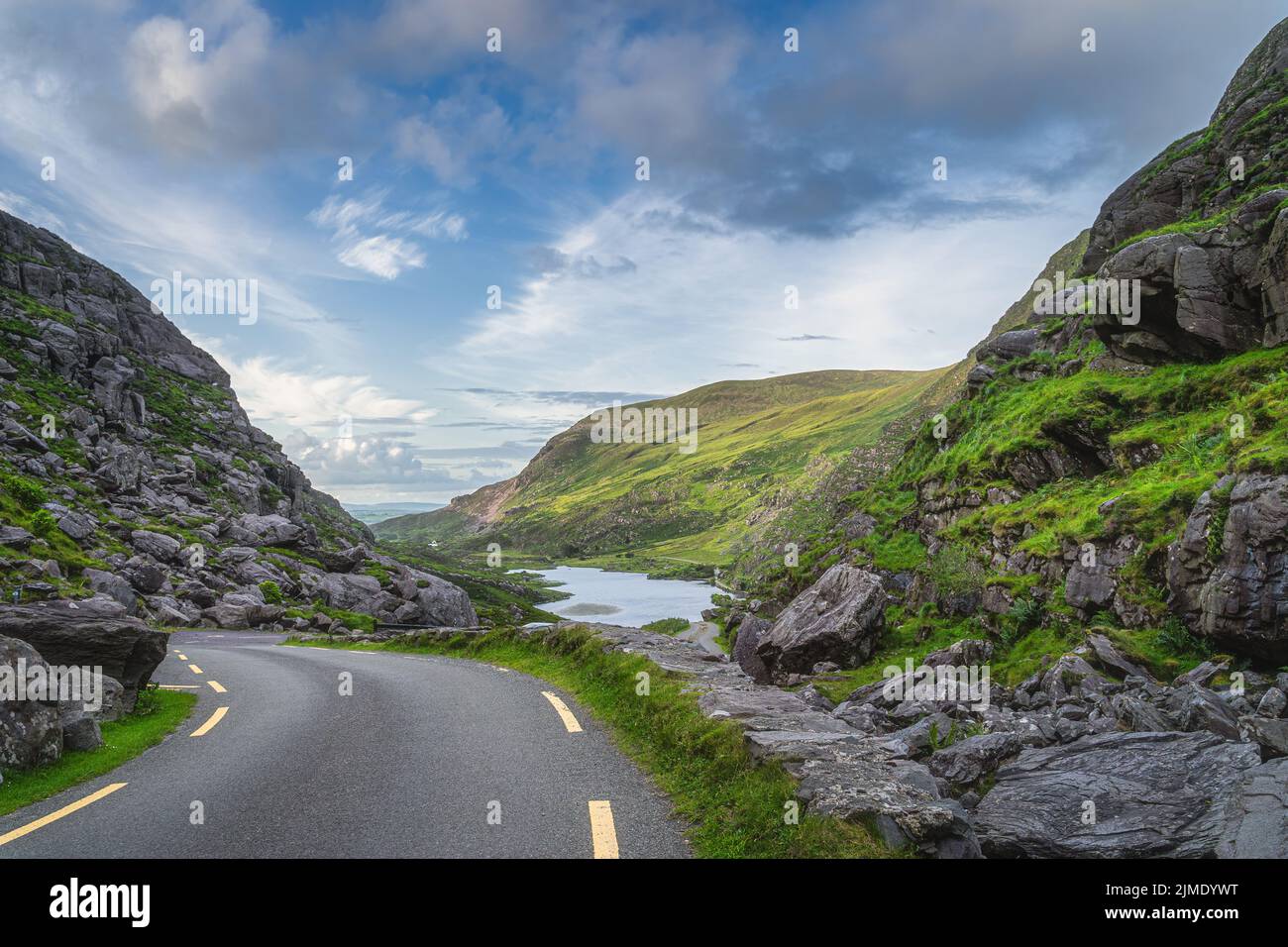 Winding road running through Gap of Dunloe with view on lake and green ...