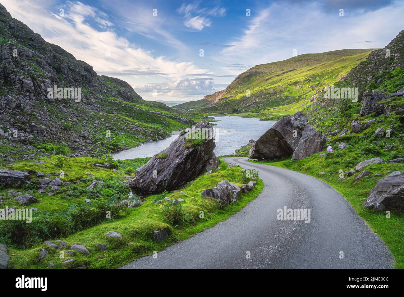 Winding road going between two halves of split rock or boulder in Gap ...