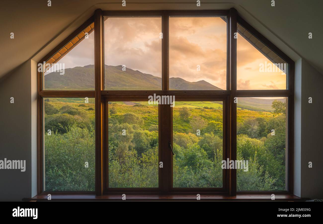 View through the window on beautiful sunrise over Carrauntoohil ...