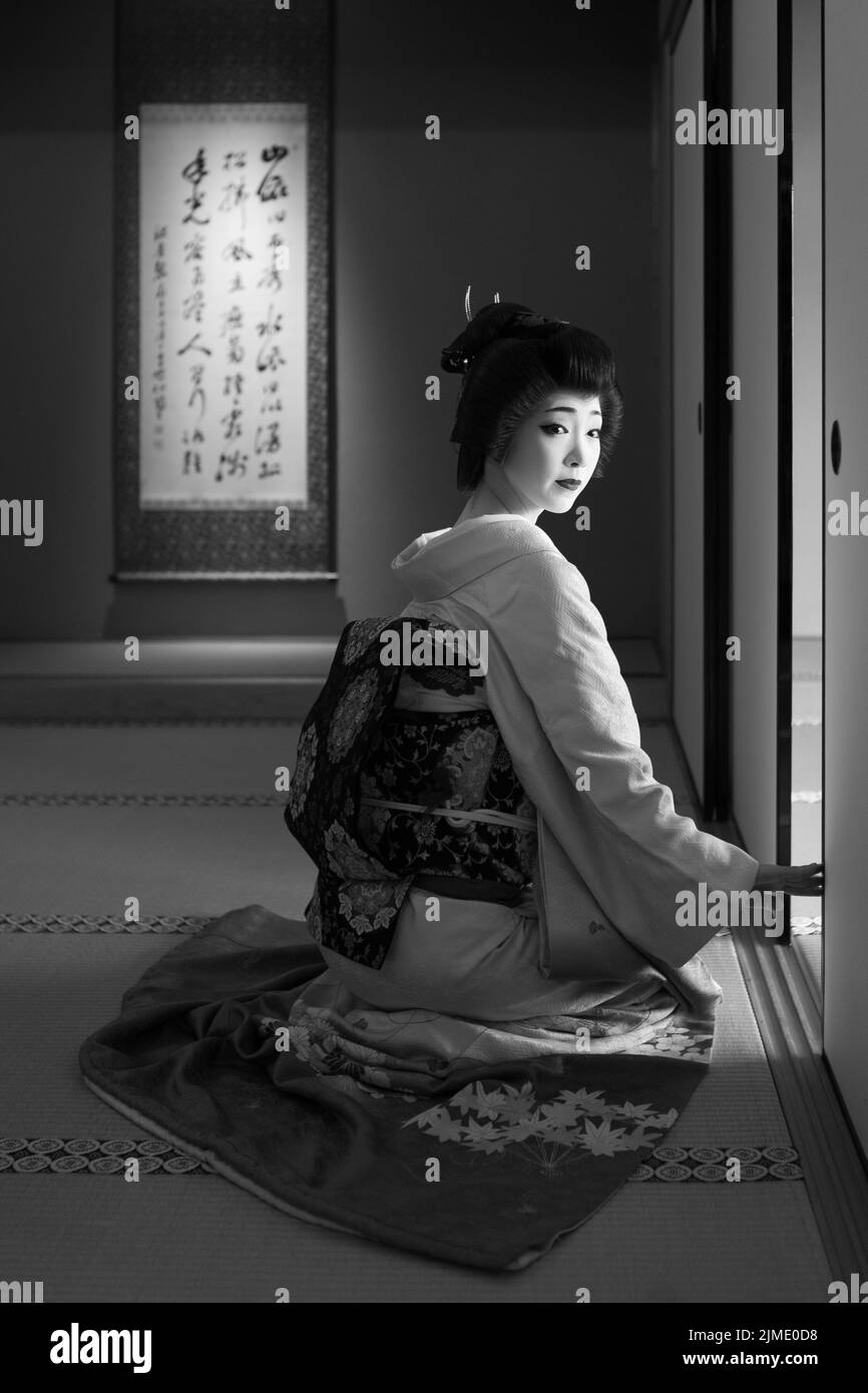 Geiko (Geisha) opening sliding door, Kyoto, Japan Stock Photo - Alamy