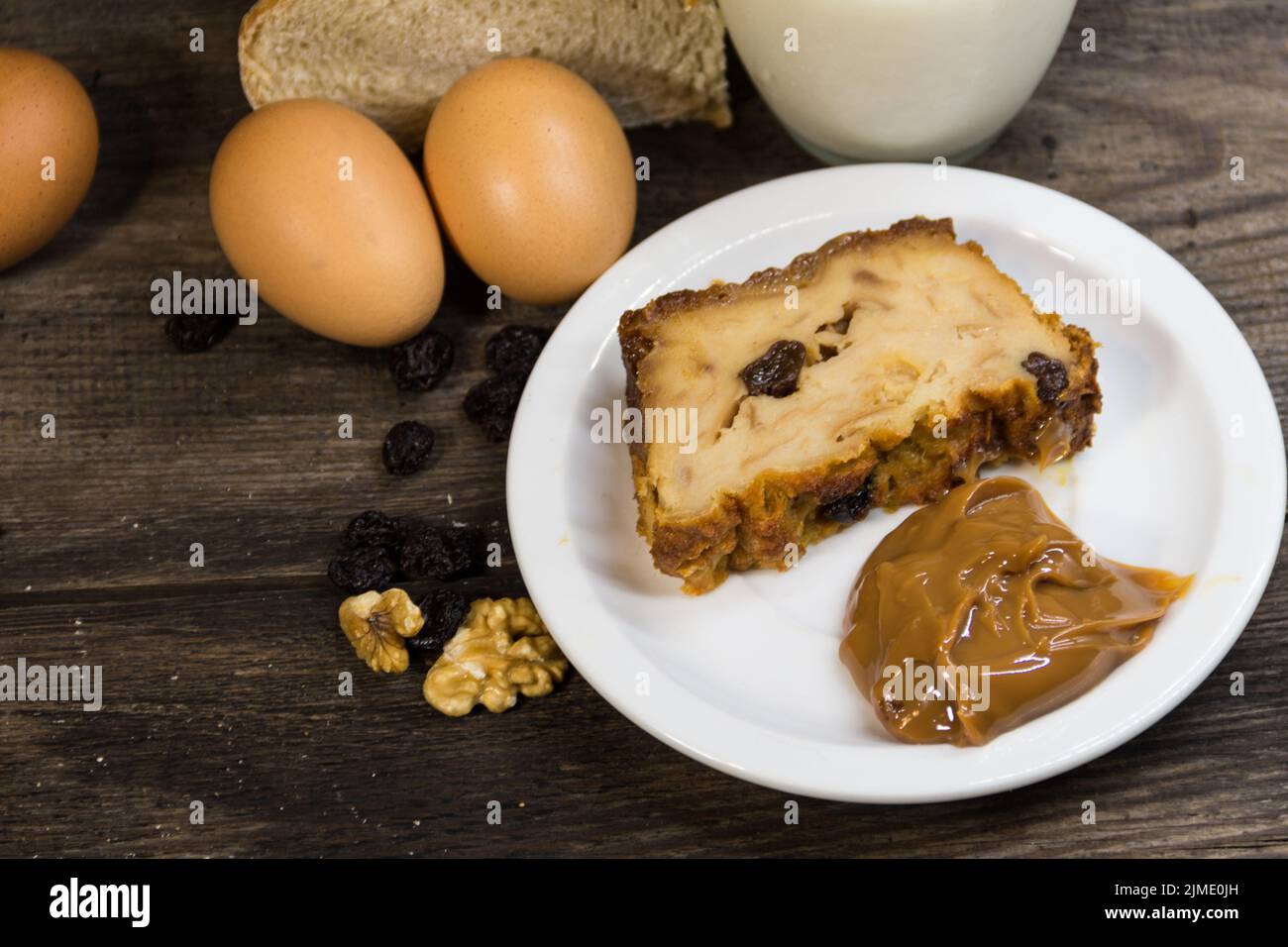 Portion of Bread pudding, made with milk, eggs, stale bread and fruits ...