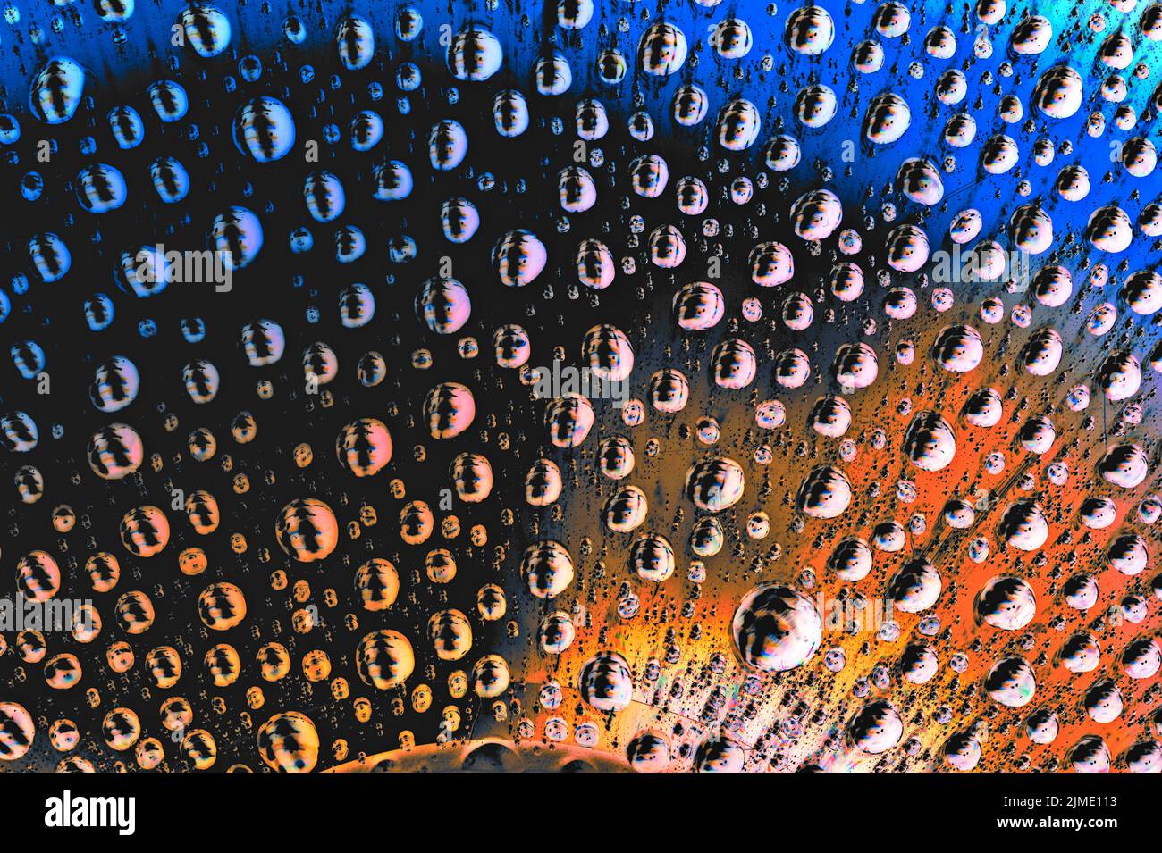 Macro of water drops on multicolor background Stock Photo - Alamy