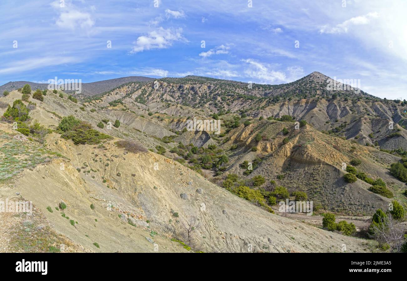 Clay ravines at the foot of the mountains Stock Photo - Alamy