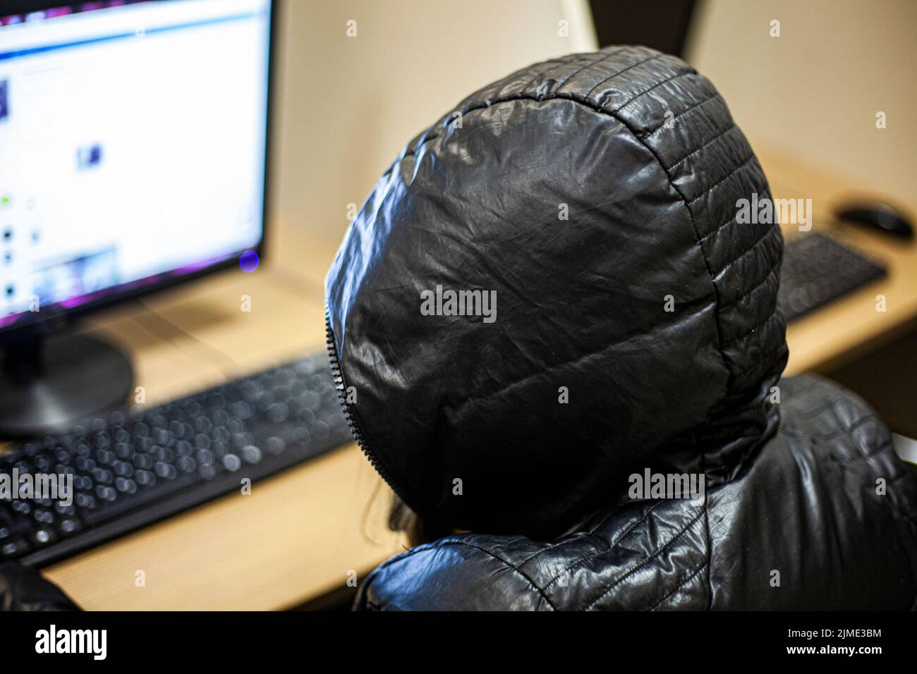 A hacker is sitting at a computer. Anonymous Internet Stock Photo - Alamy