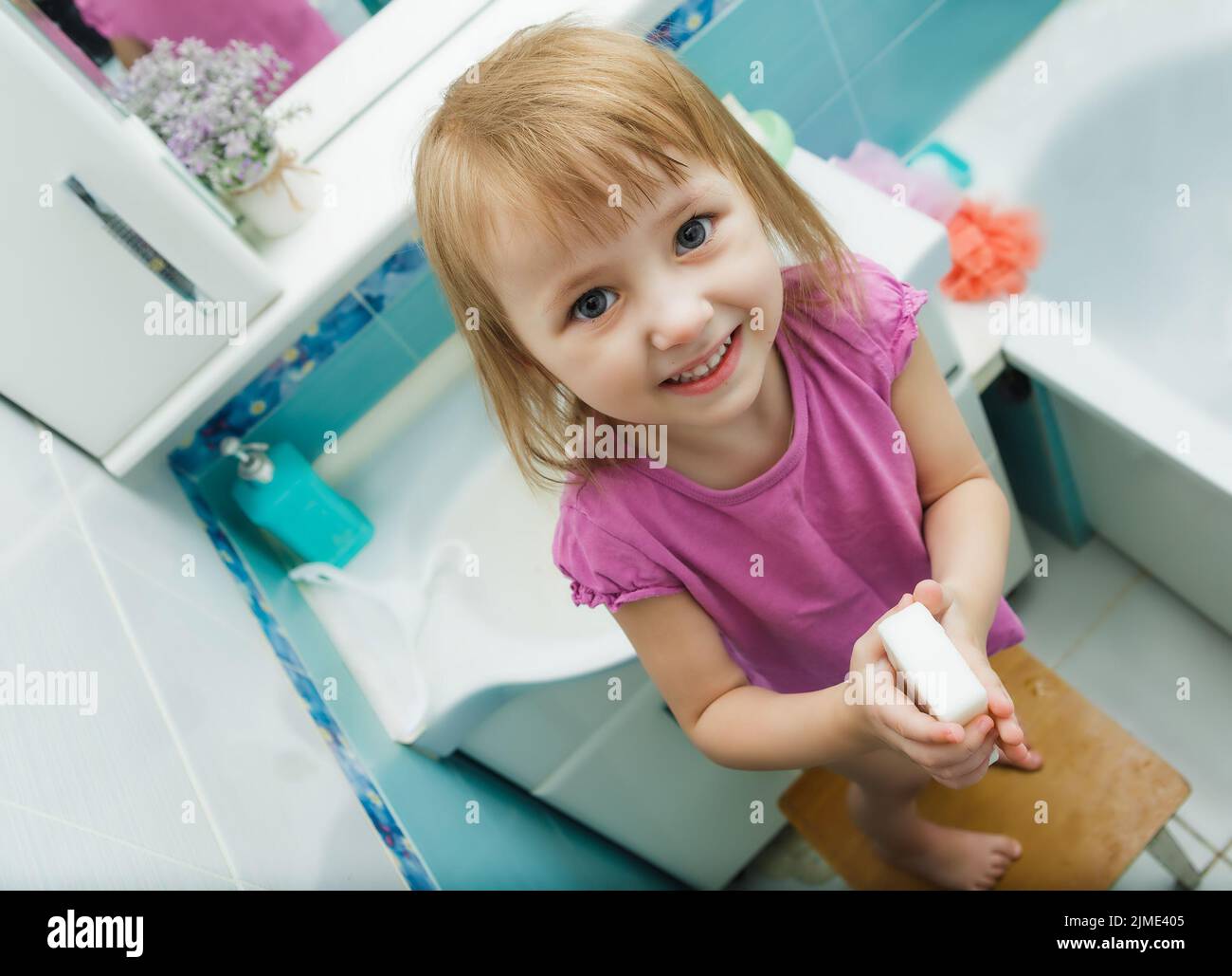 Smiling little girl holding soap in the bathroom Stock Photo - Alamy Smiling little girl holding soap in the bathroom Stock Photo - Alamy