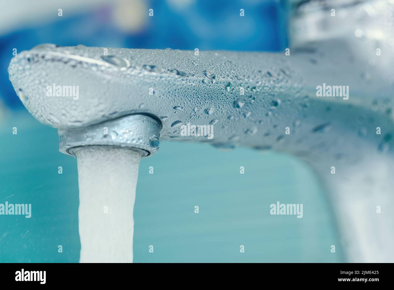 Water drops on the faucet in the bathroom. Macro photo Stock Photo - Alamy