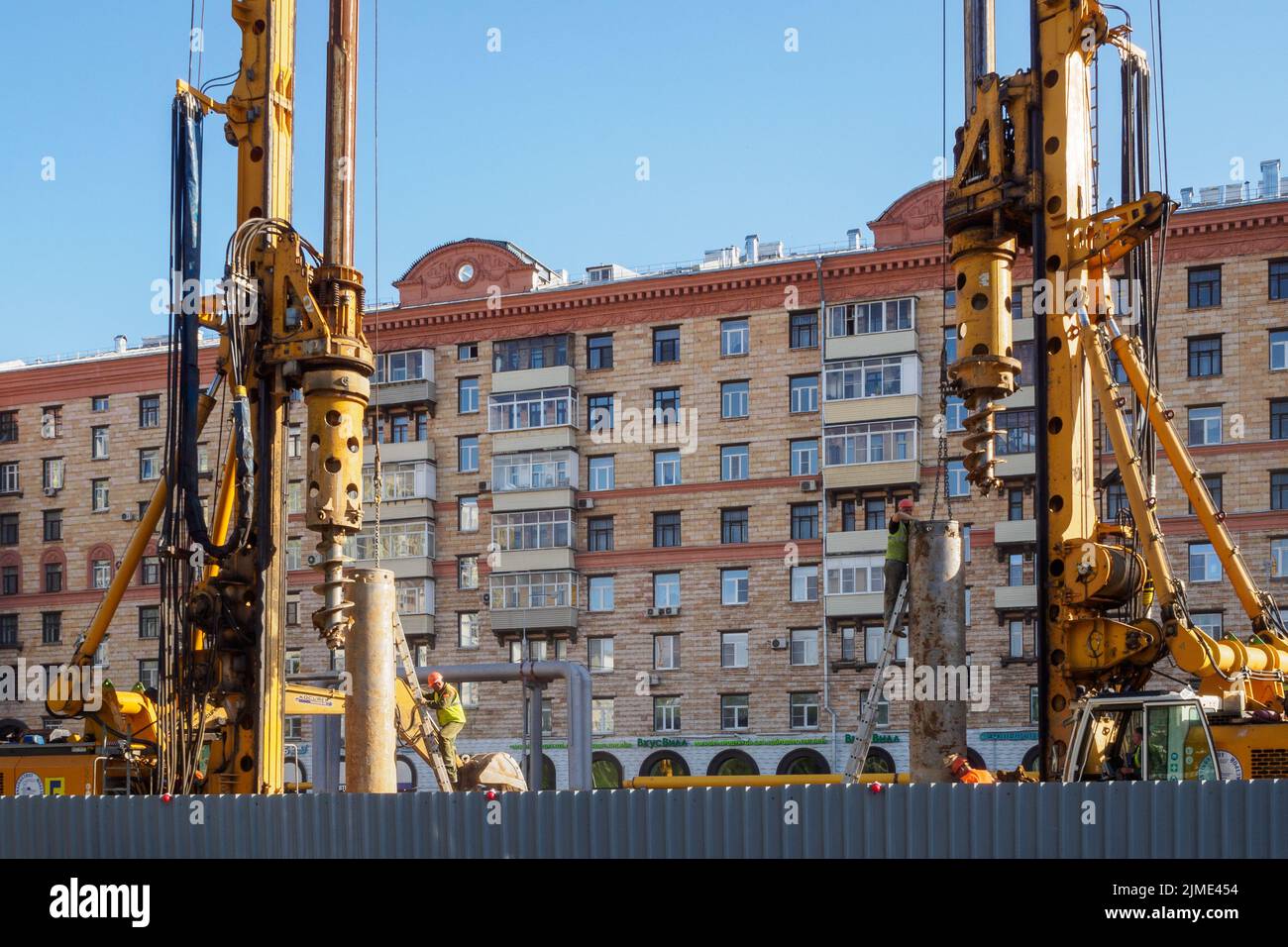 Huge yellow heavy machines for driving piles on a city street Stock ...
