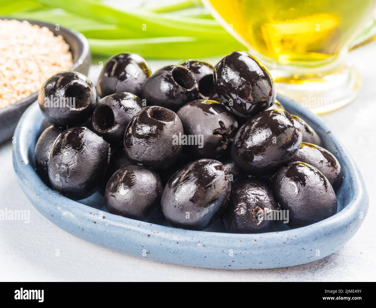 Black olives in blue plate Stock Photo - Alamy