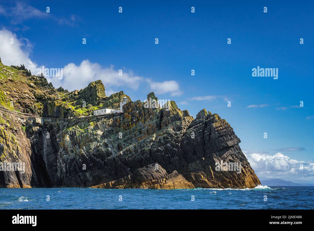 Skellig Lighthouse located on the edge of the cliff on Skellig Michael ...
