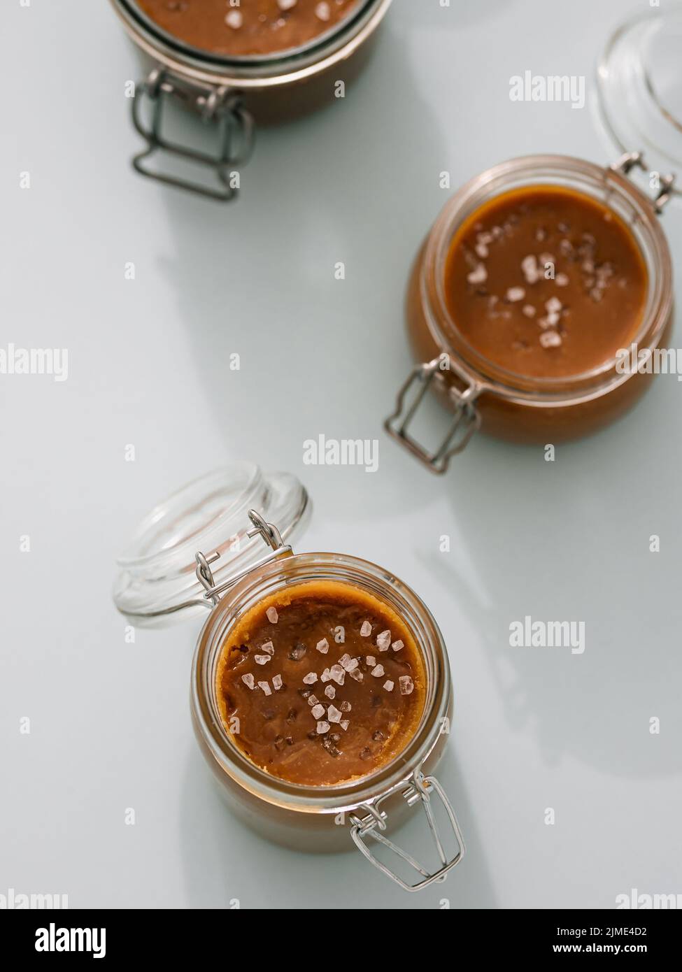 Salted caramel in glass jars, top view. Vertical Stock Photo - Alamy