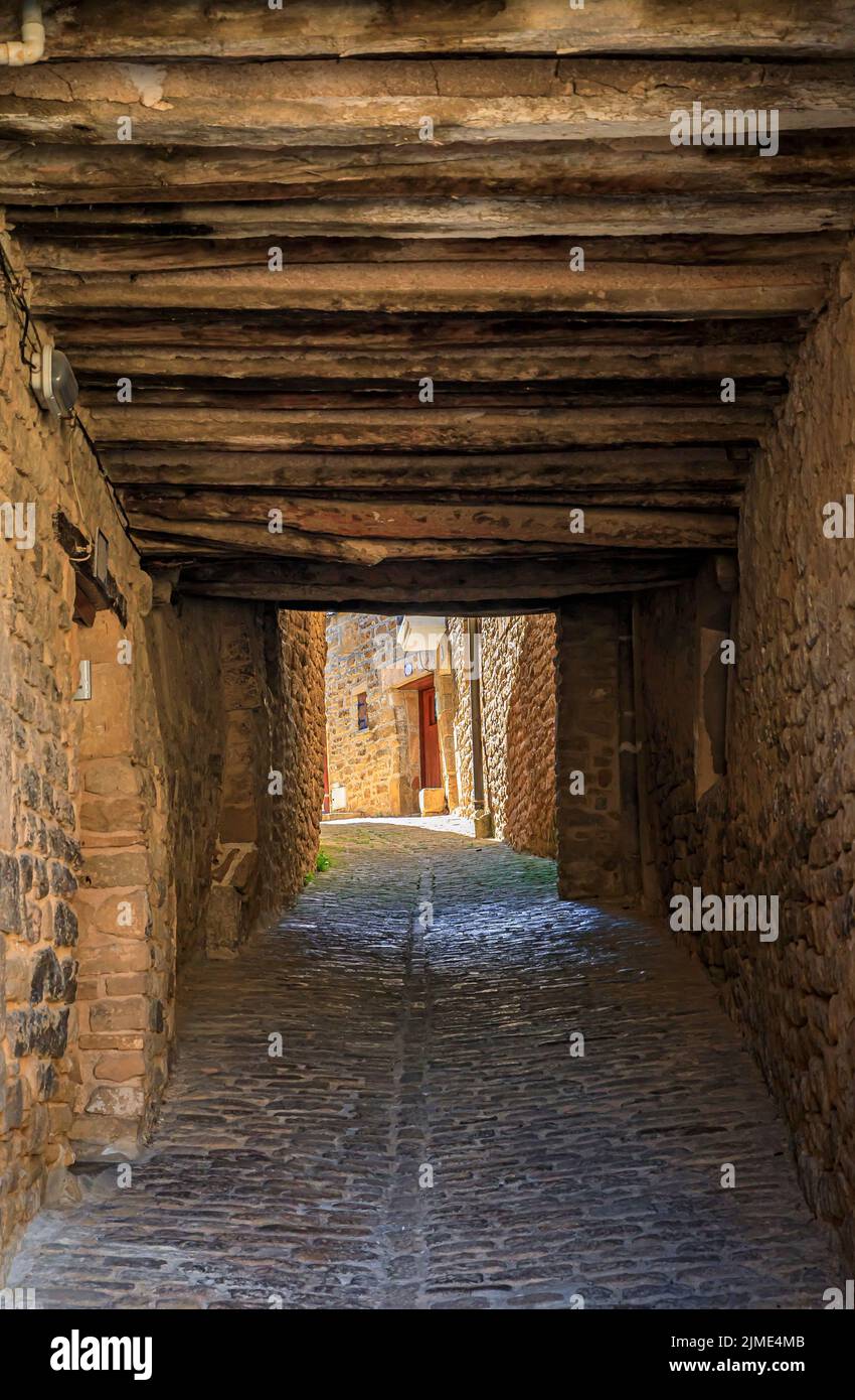 Old stone houses and narrow arched passage in a picturesque medieval ...