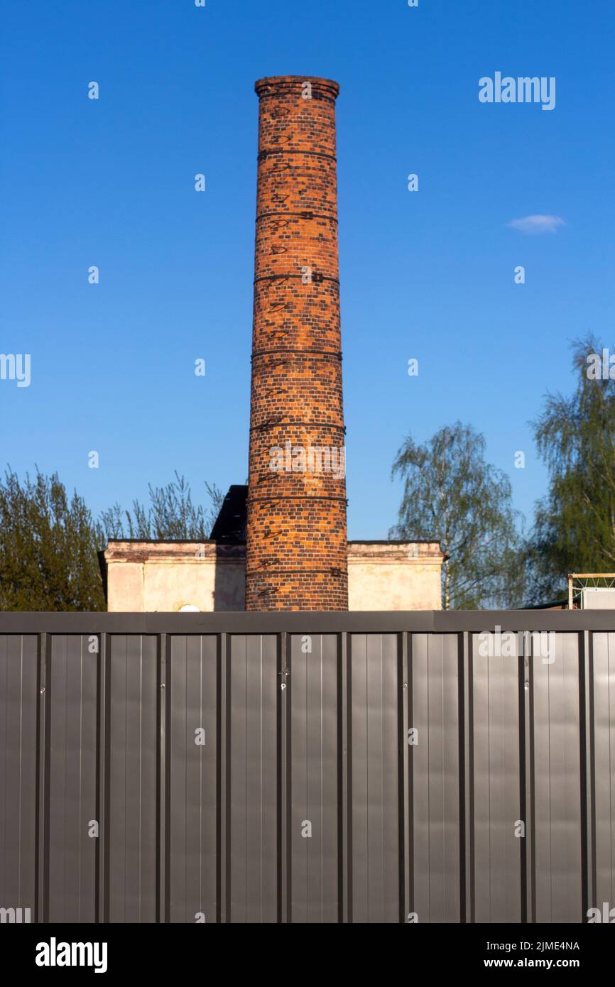 Factory brick pipe. A brick chimney rises against the sky Stock Photo ...