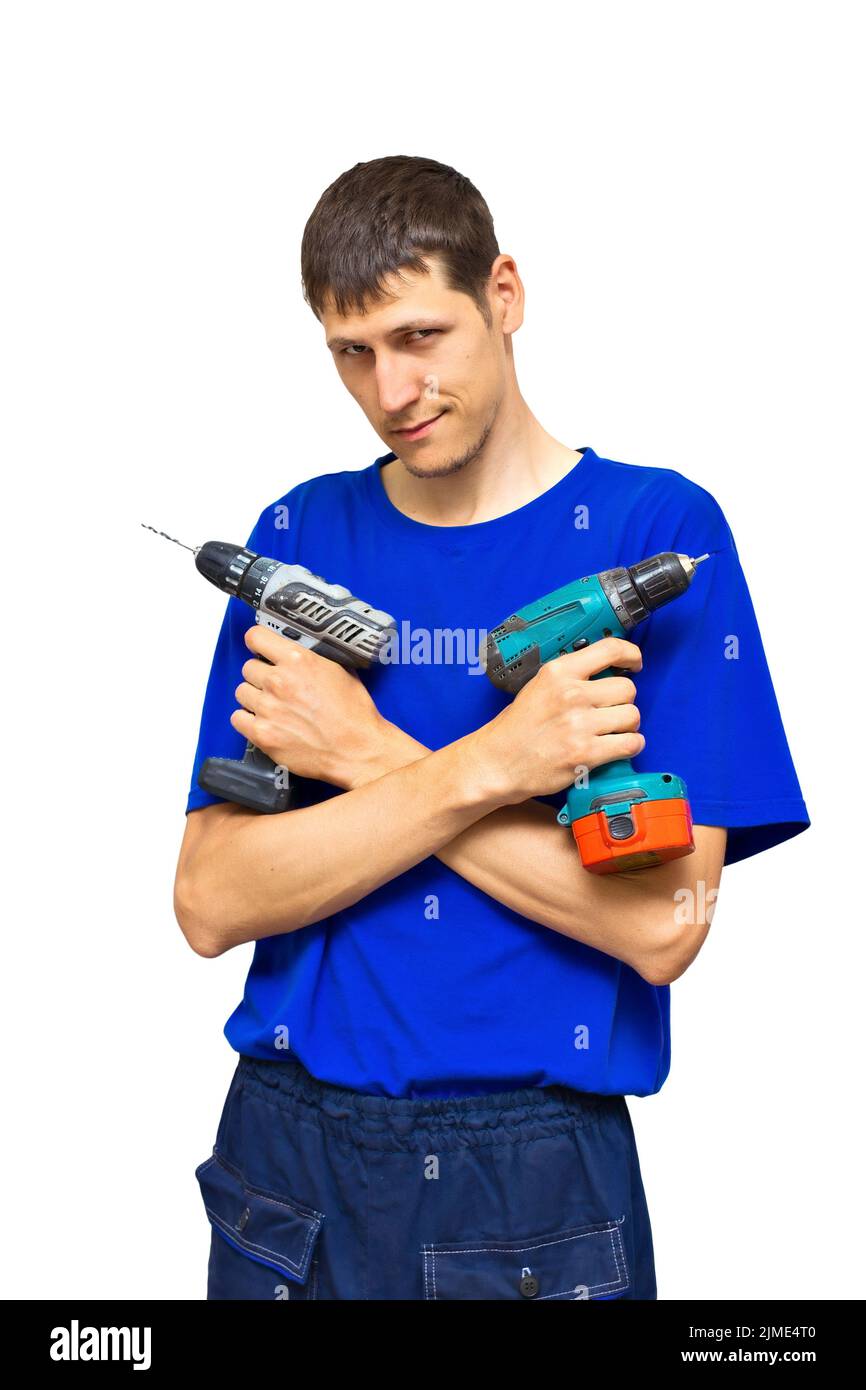 A young utility worker holds electric screwdrivers in his hands ...