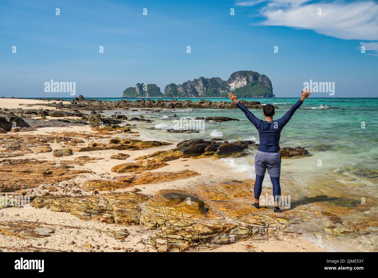 Tropical islands view with man tourist looking at ocean blue sea water ...