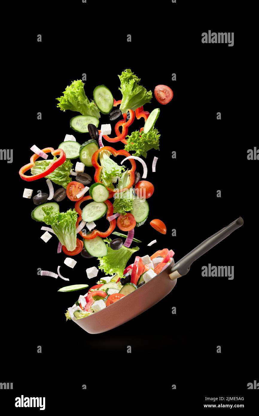 Frying pan with falling vegetables Stock Photo - Alamy