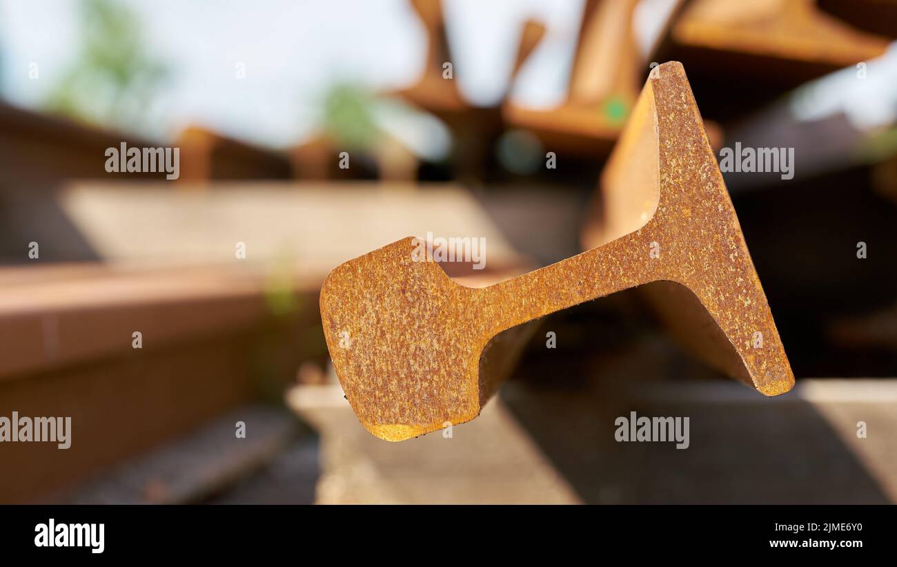 Close up of the cross section of a rusty railroad rail in a storage ...