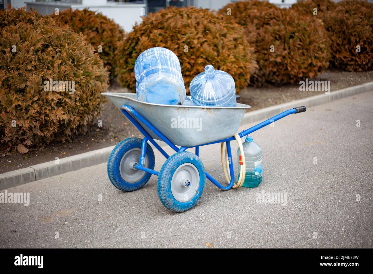 Garden cart. Watering tools for plants Stock Photo - Alamy