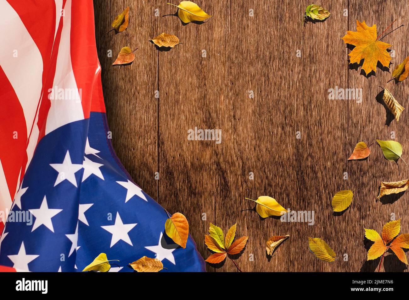 little flag of USA with maple leaves on wooden table. Above view Stock ...