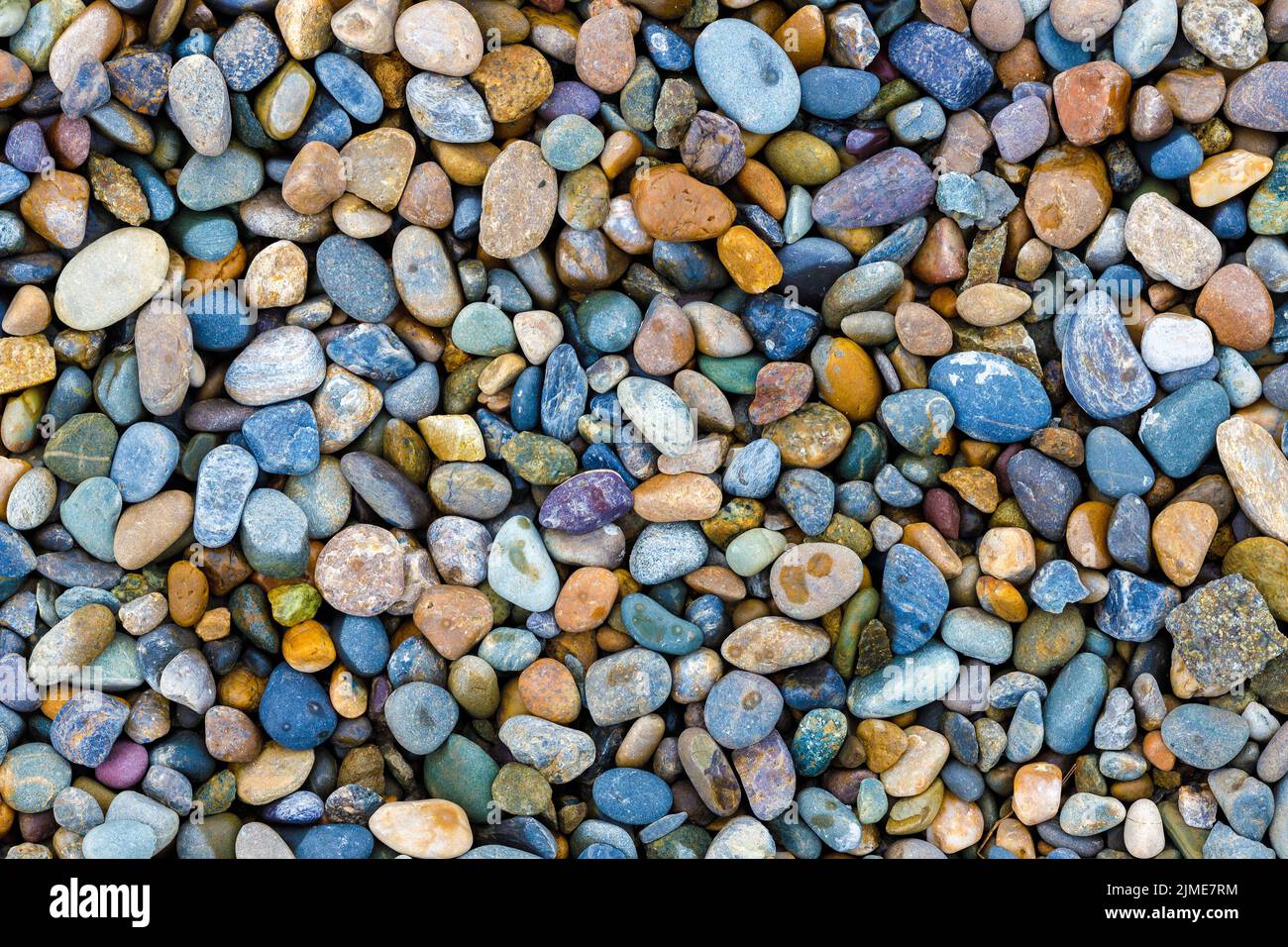 These are wet river pebbles and small round pebbles. Solid background ...