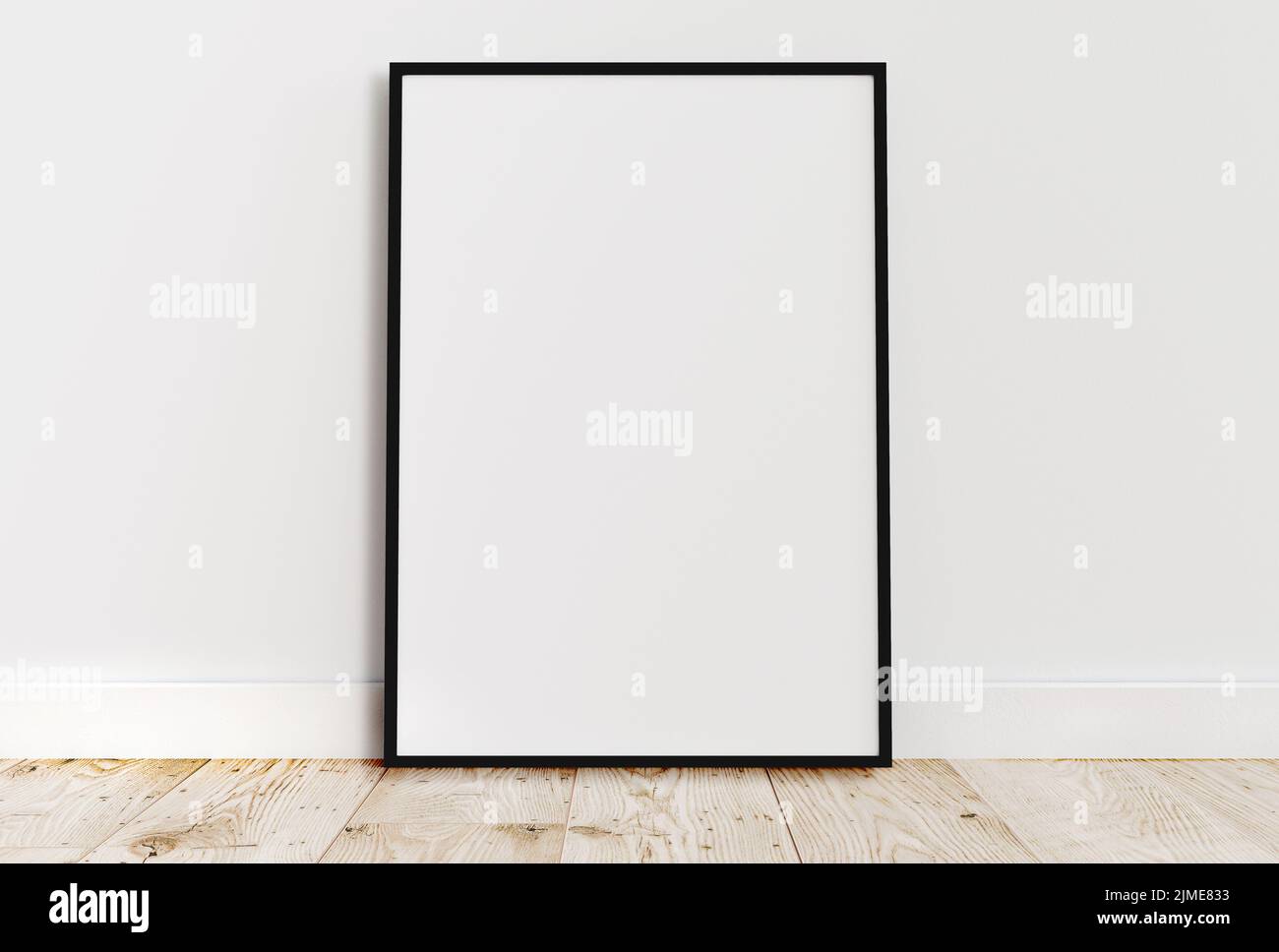 Empty thin black frame on light wooden floor with white wall behind it ...