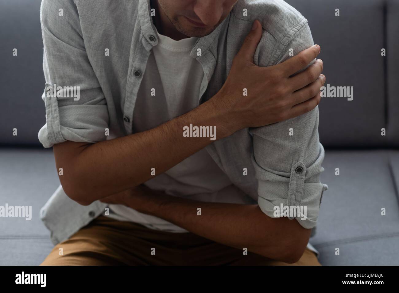 Shoulder pain. The man's shoulder hurts. A Band-Aid Stock Photo - Alamy