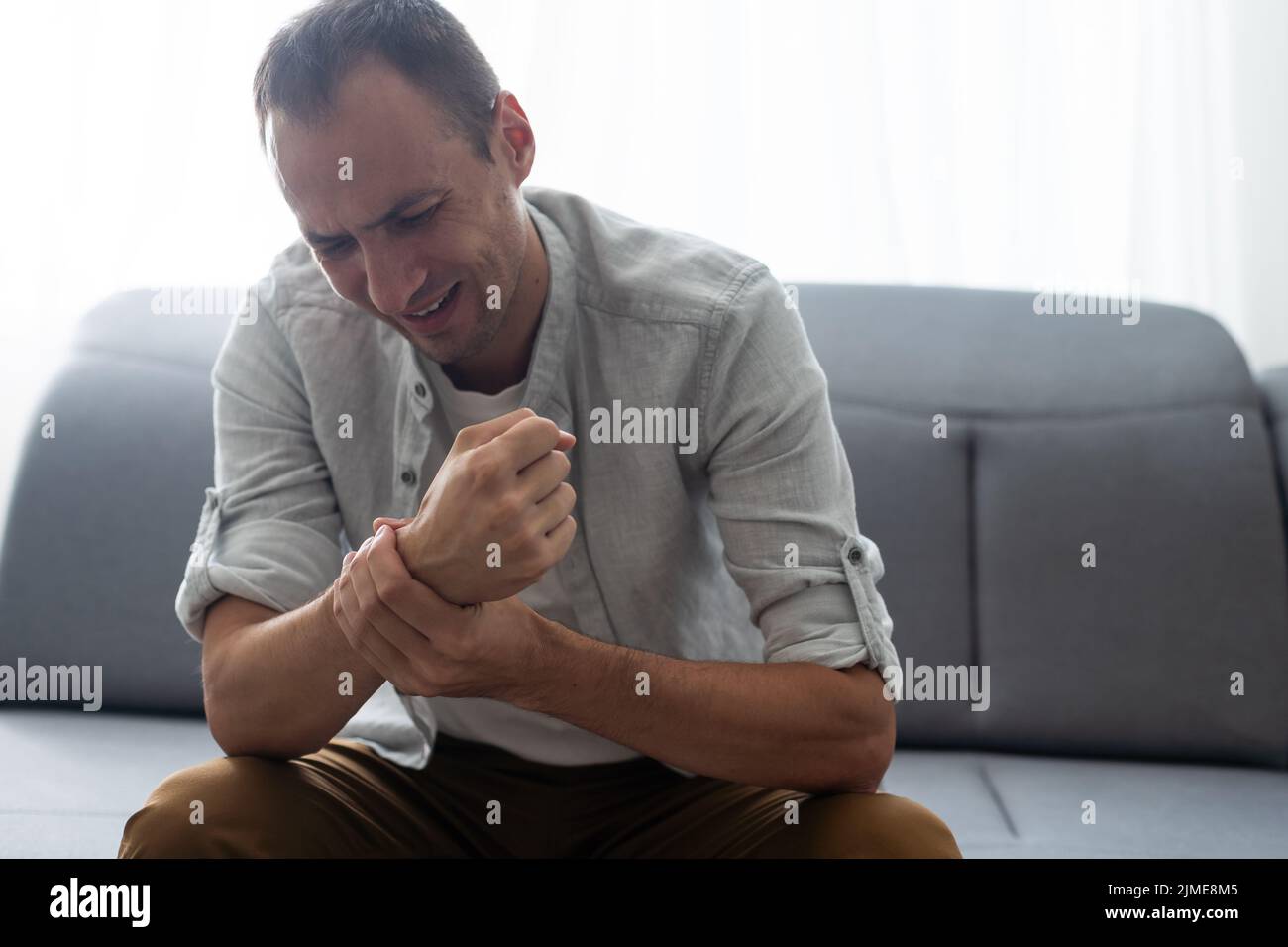 Man's arm touches a painful wrist caused by work Stock Photo - Alamy Man's arm touches a painful wrist caused by work Stock Photo - Alamy