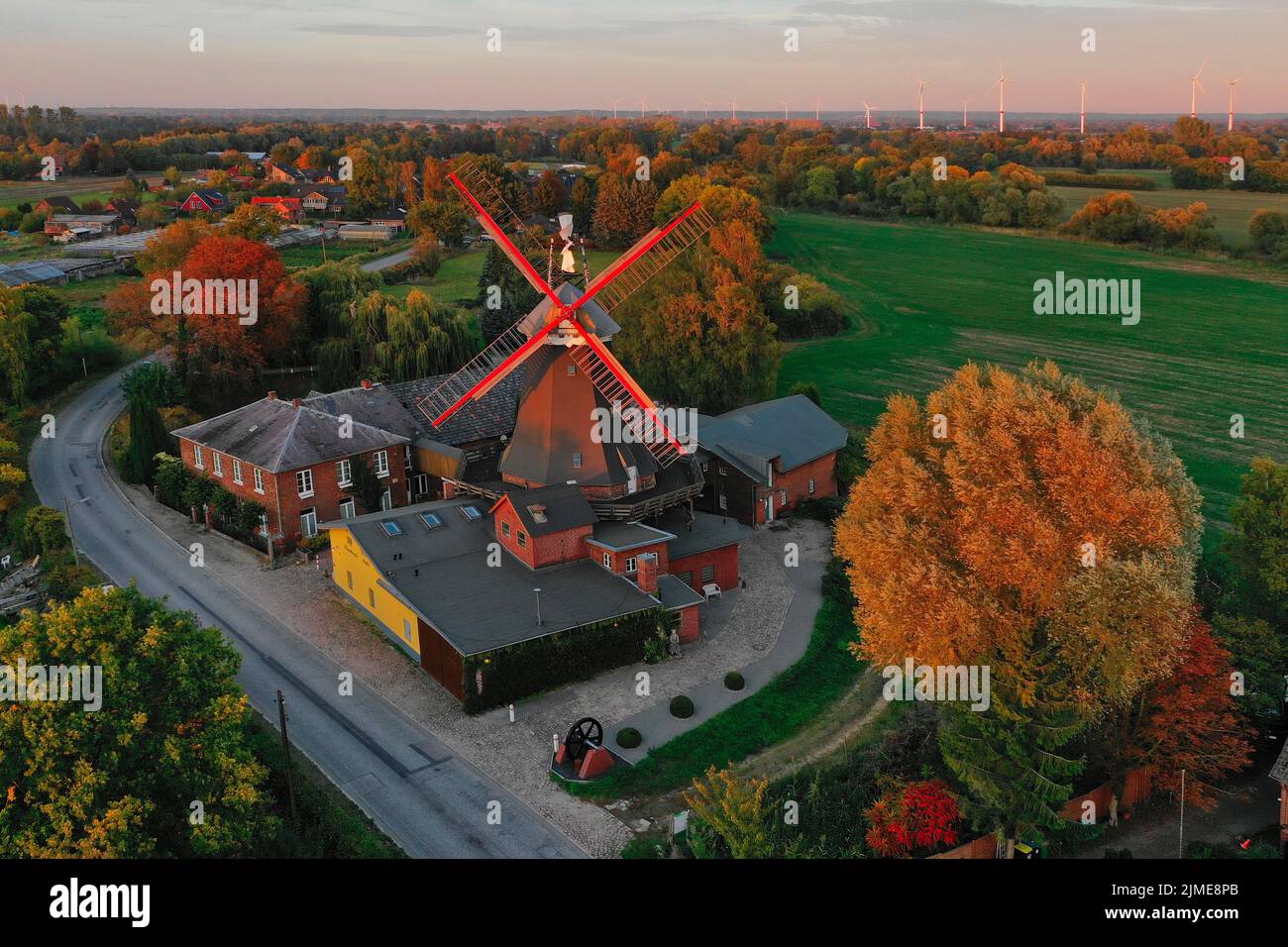 The aerial view of an old windmill and farmhouses in the countryside at ...