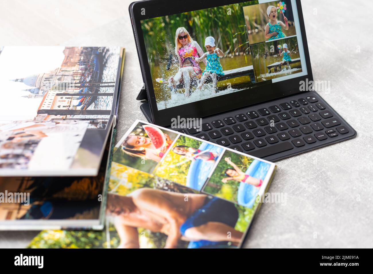 photobook album and tablet on the table Stock Photo - Alamy