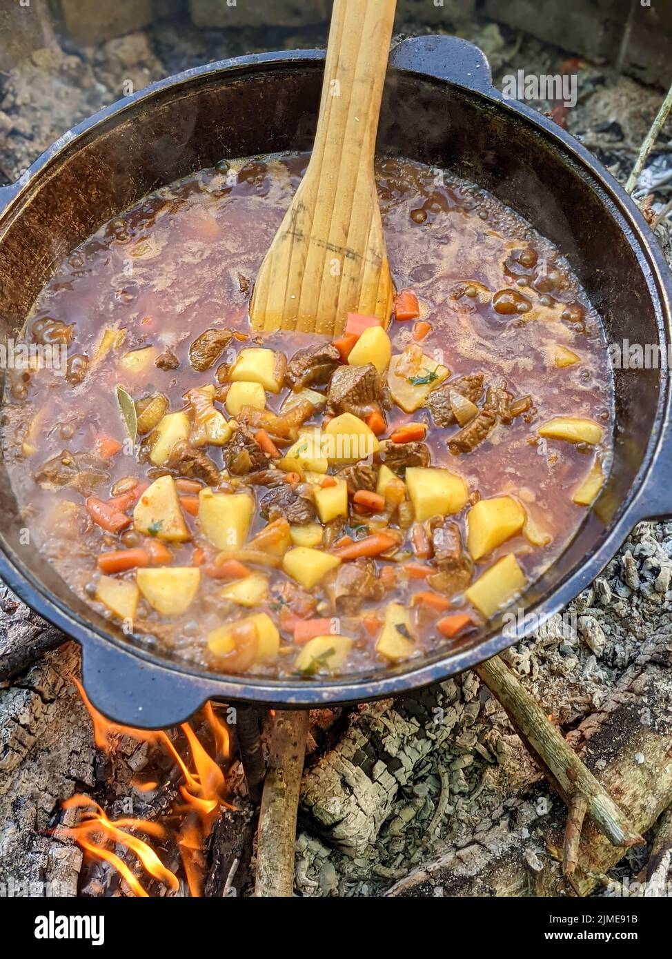 Gourmet beef stew cooked in cauldron on outdoor fire pit Stock Photo ...