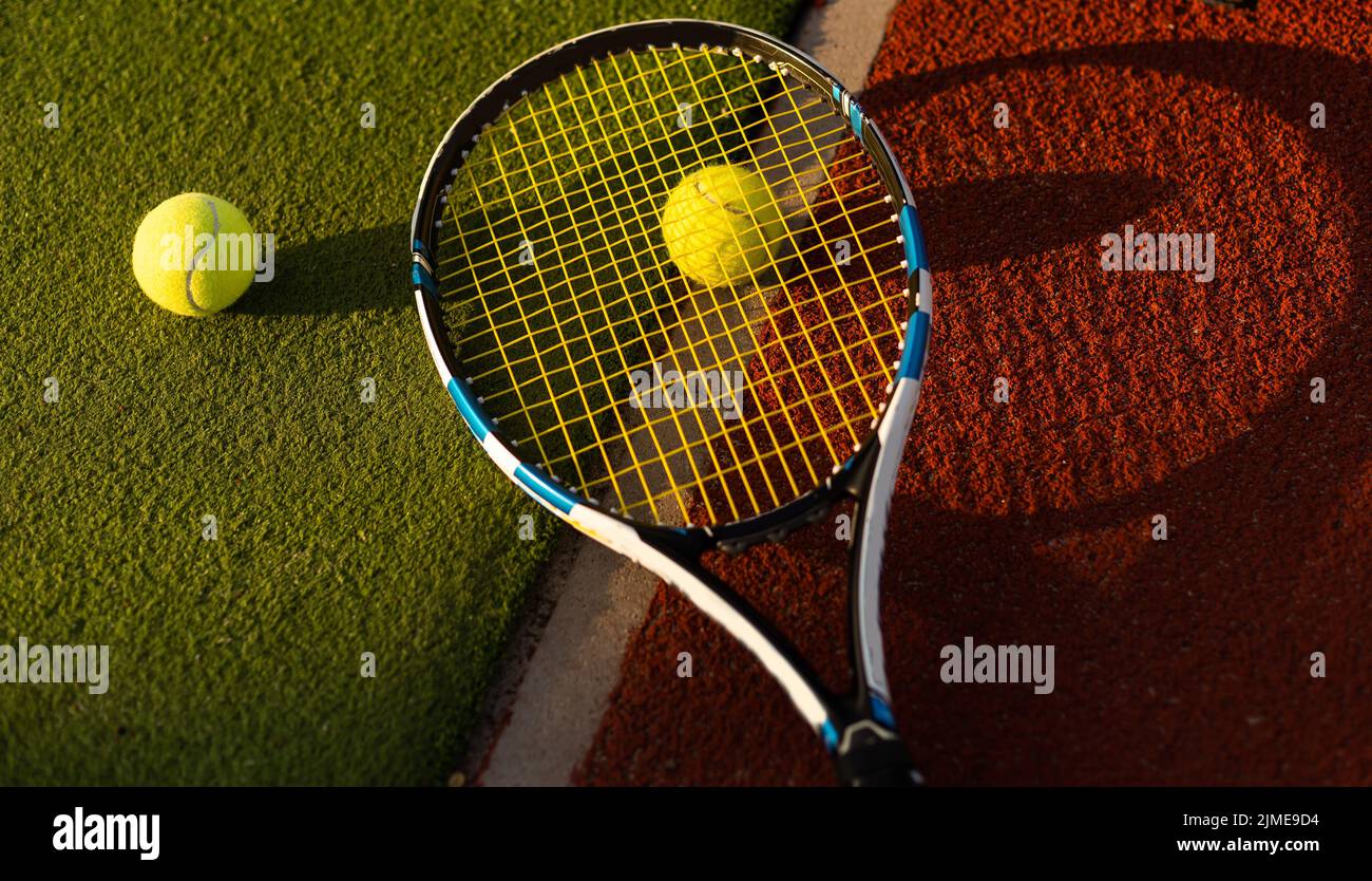 tennis balls and racket on the green grass background Stock Photo - Alamy