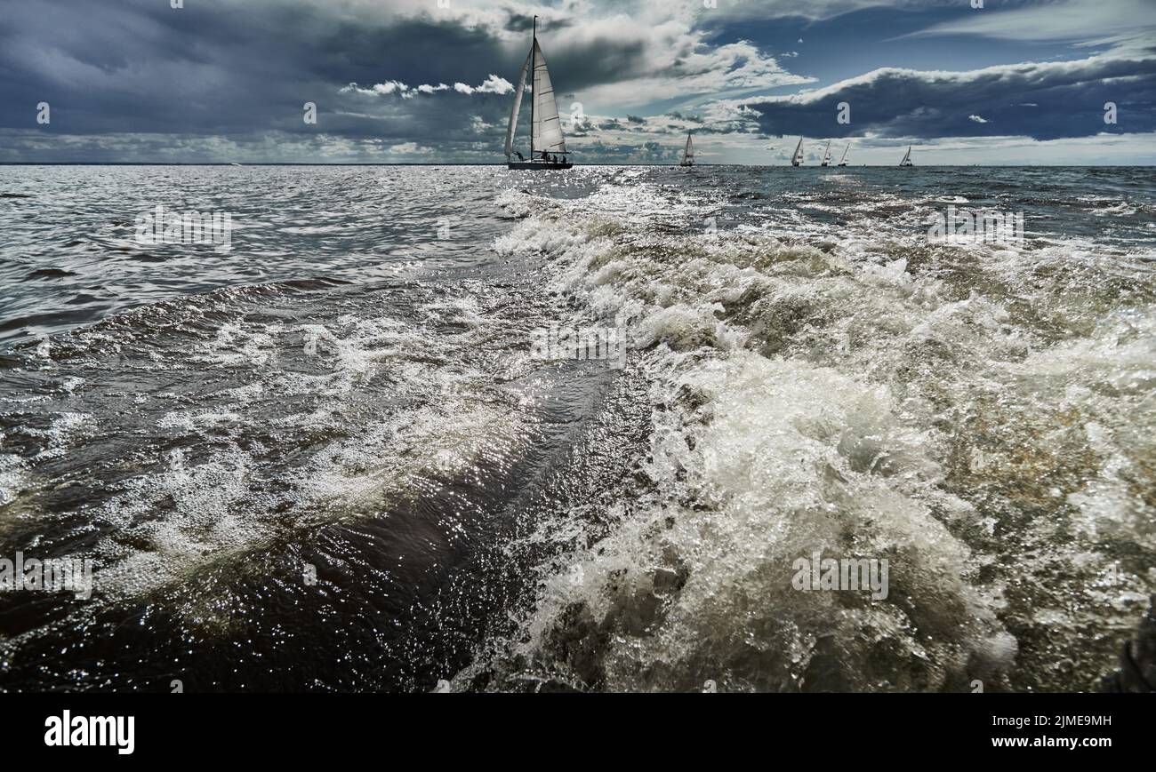 Competition of sailboats in regatta at storm weather, race, big waves ...