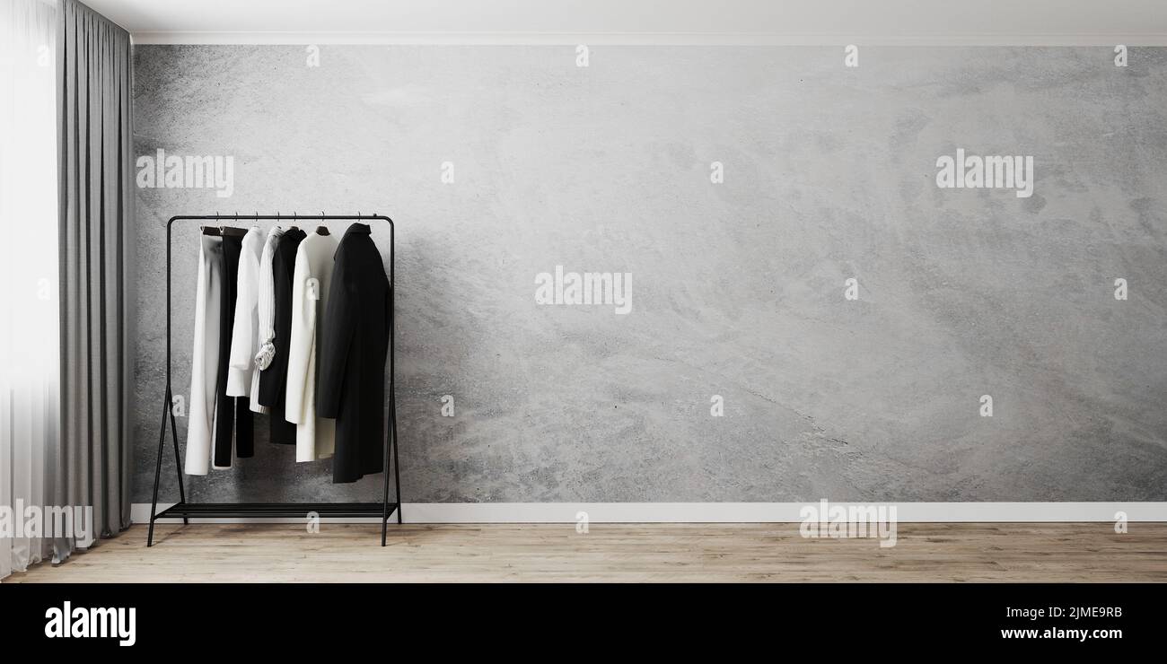Clothes rack with gray empty wall near window with gray curtain ...