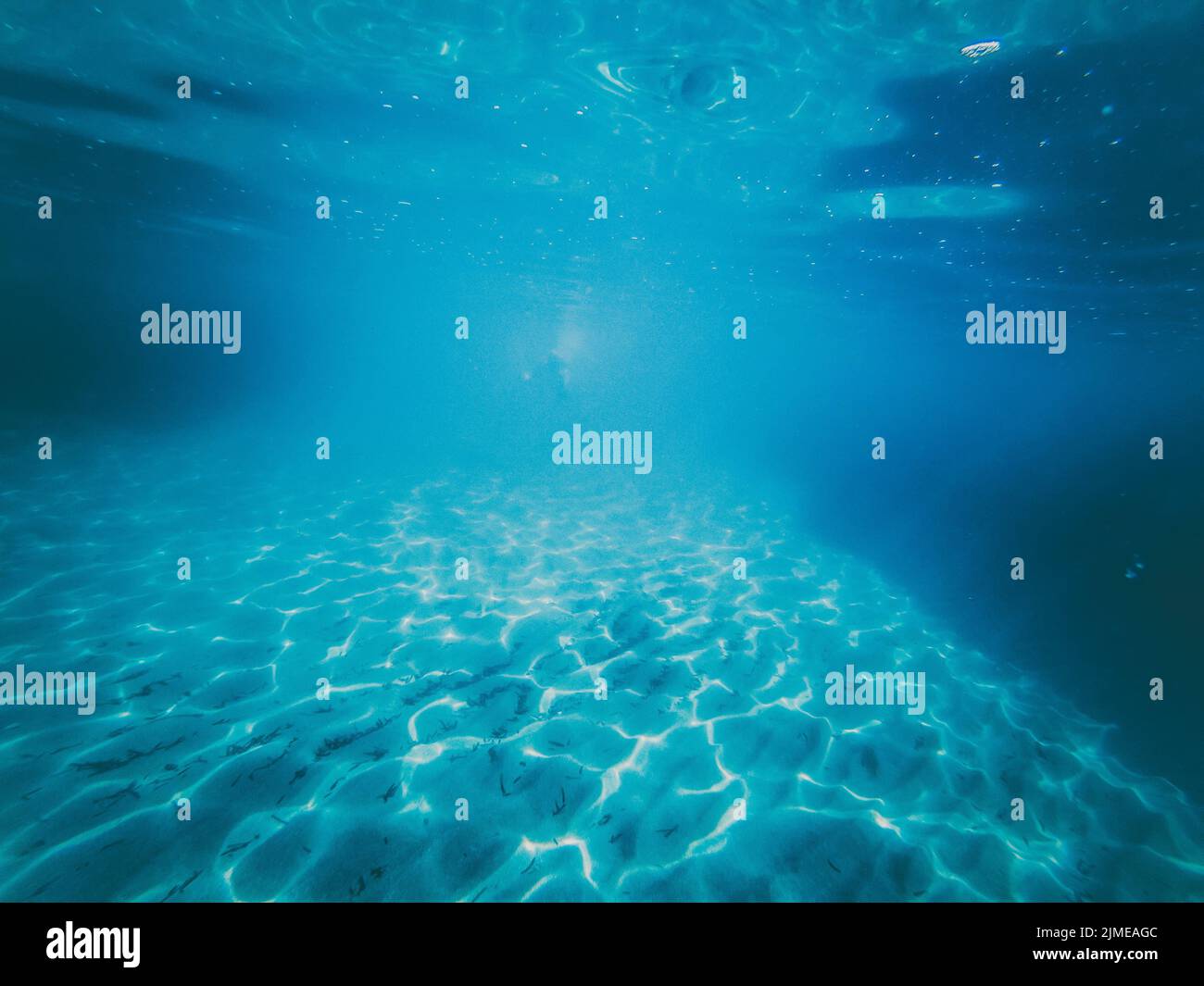 Blue colored clear underwater surface texture with ripples splashes and ...
