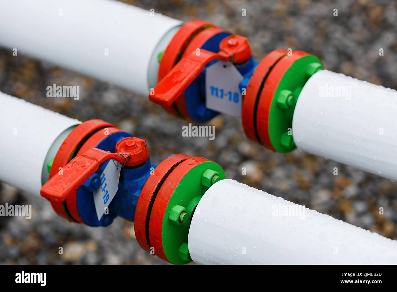 New shut-off valves pipeline close-up. These are white pipes and a red ...