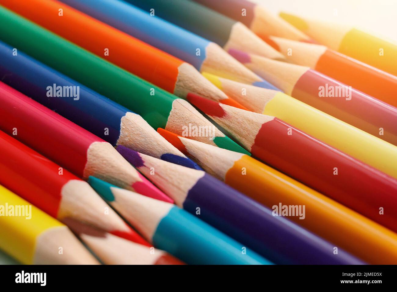 Colored sharpened pencils lie in a row close-up. Solid abstract ...