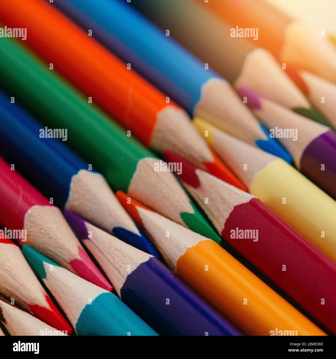 Colored sharpened pencils lie in a row close-up. Solid abstract ...