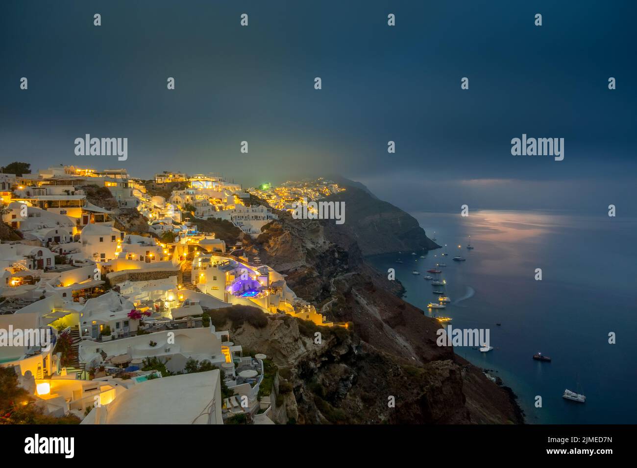 Cloudy Night and Oia Lights on the Island of Thira Stock Photo - Alamy