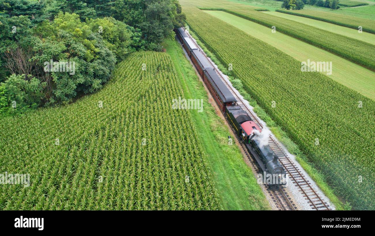 Aerial View of a Steam Locomotive Traveling Across Farmland Landscape ...