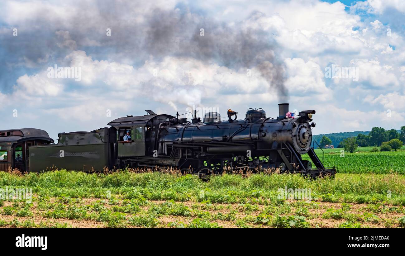 View of an Antique Restored Steam Passenger Train Blowing Smoke and ...