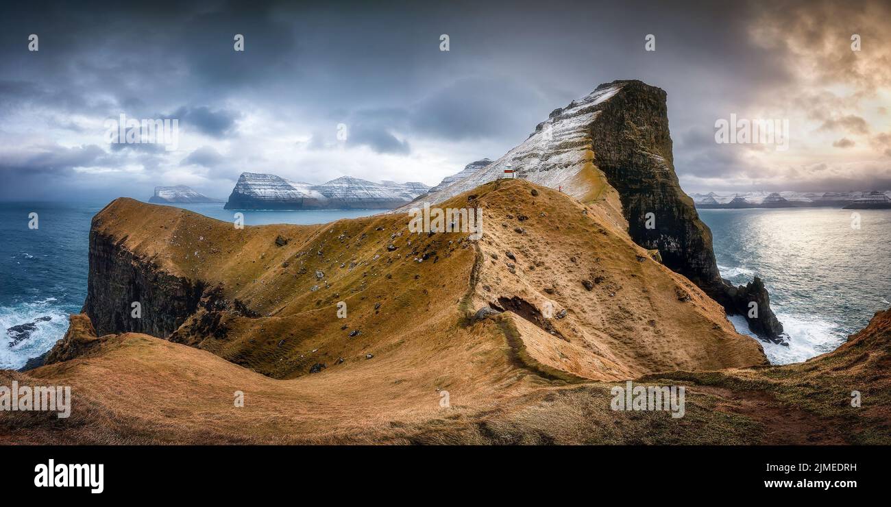 Scenic view of Kallur lighthouse on Kalsoy island on a moody day with ...