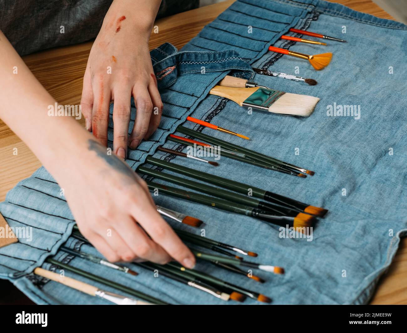 professional artist kit painter choosing brush Stock Photo - Alamy