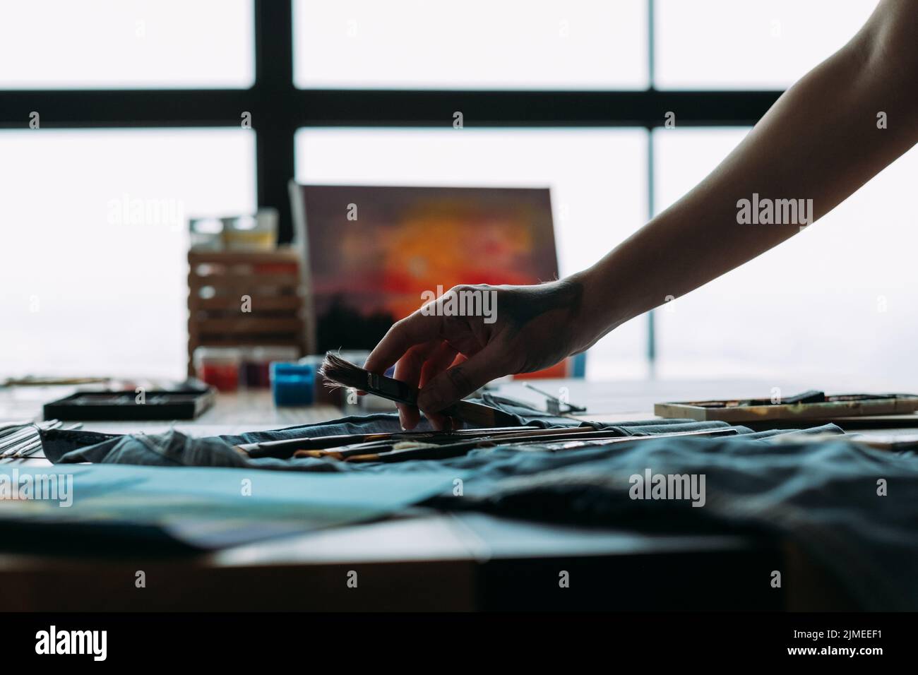 creative process artist choosing paintbrush Stock Photo - Alamy