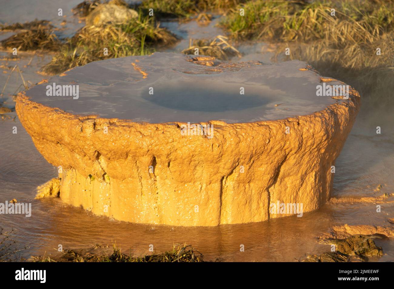 Pipe with waste. Rusty pipe sticks out of ground. Industrial ...