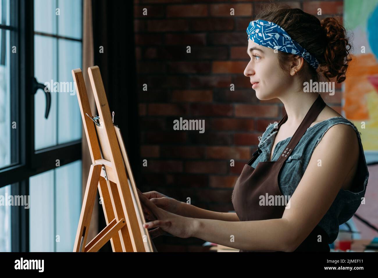 talent inspired female artist easel painting Stock Photo - Alamy