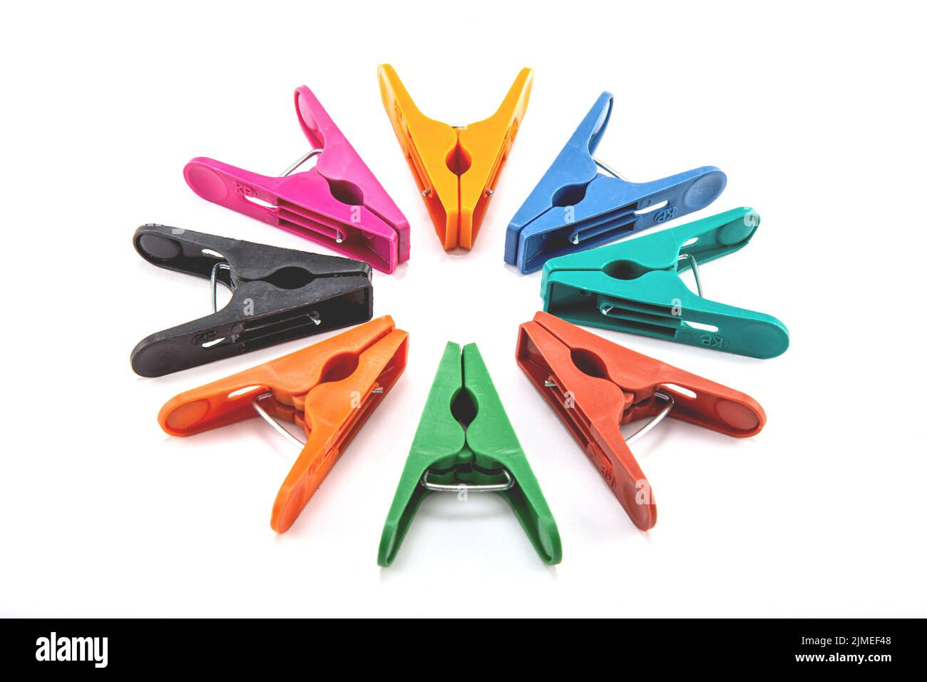 The colorful plastic cloth clips arranged in a circle on white ...